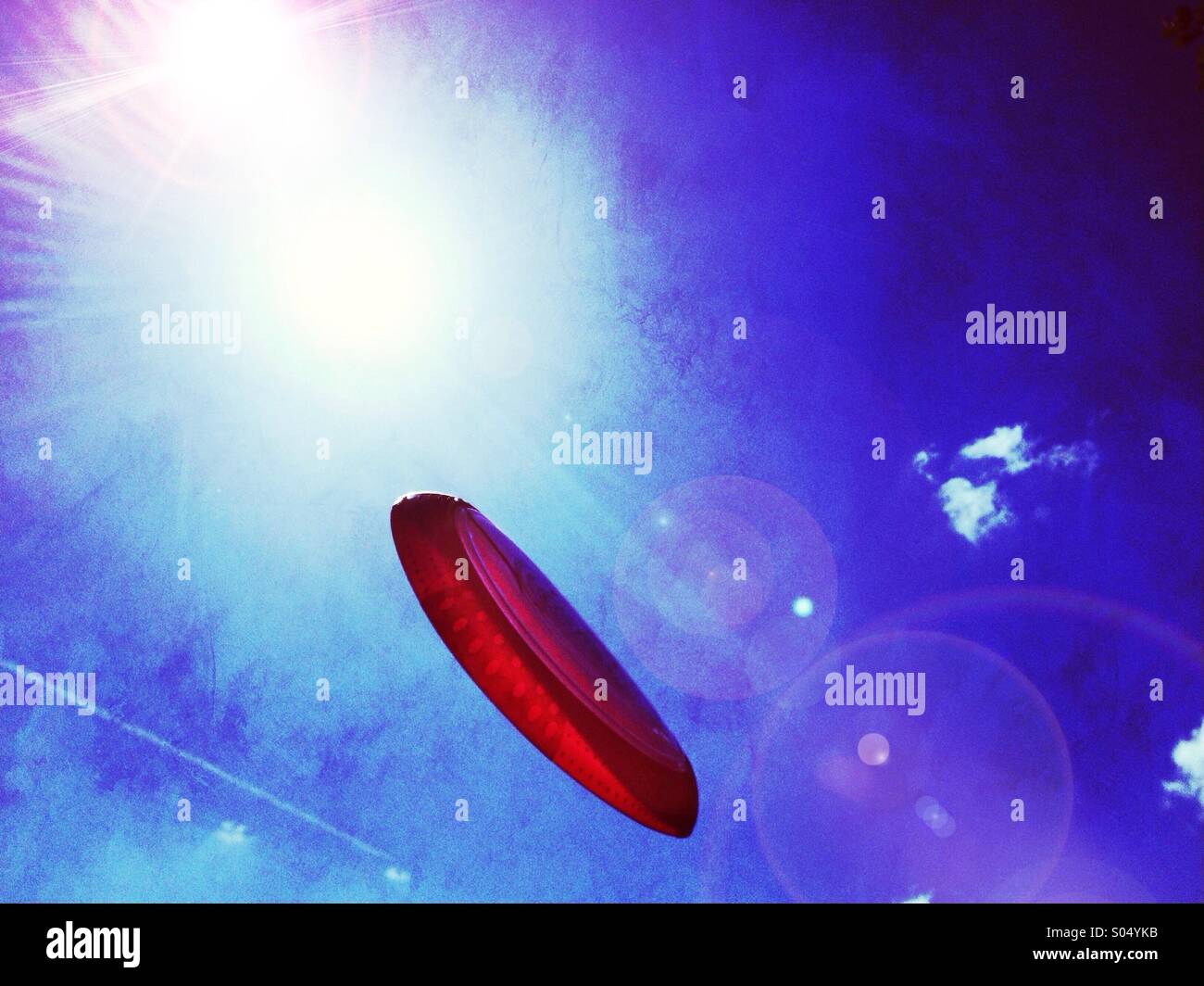 Frisbee flying against sun Stock Photo - Alamy