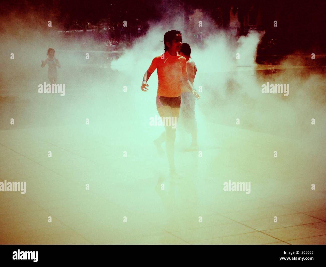 Young girl running in the mist Stock Photo - Alamy