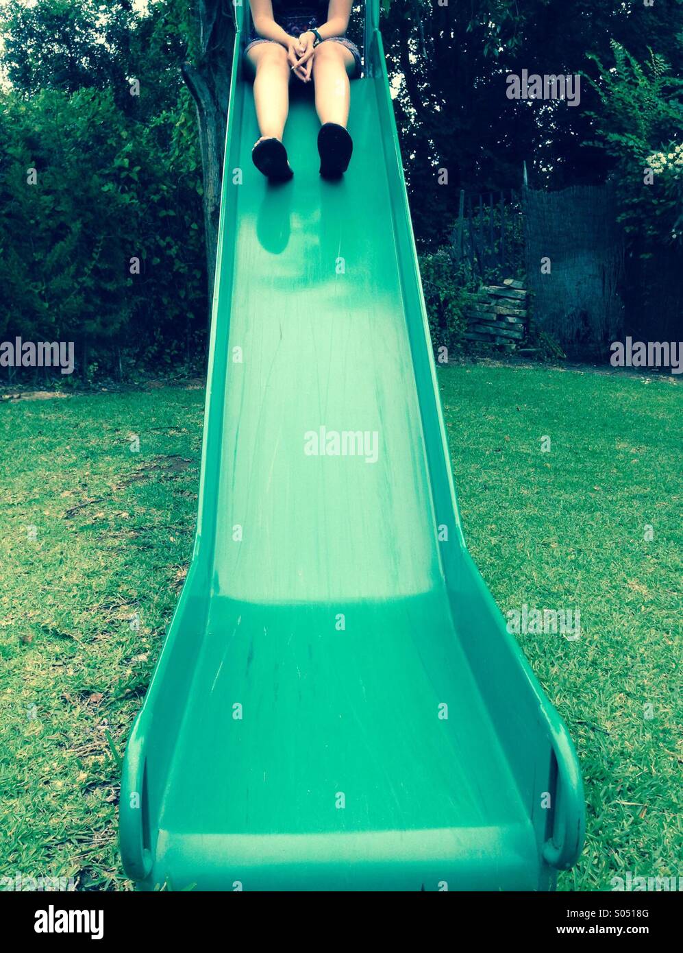 Young woman at top of the slide Stock Photo - Alamy