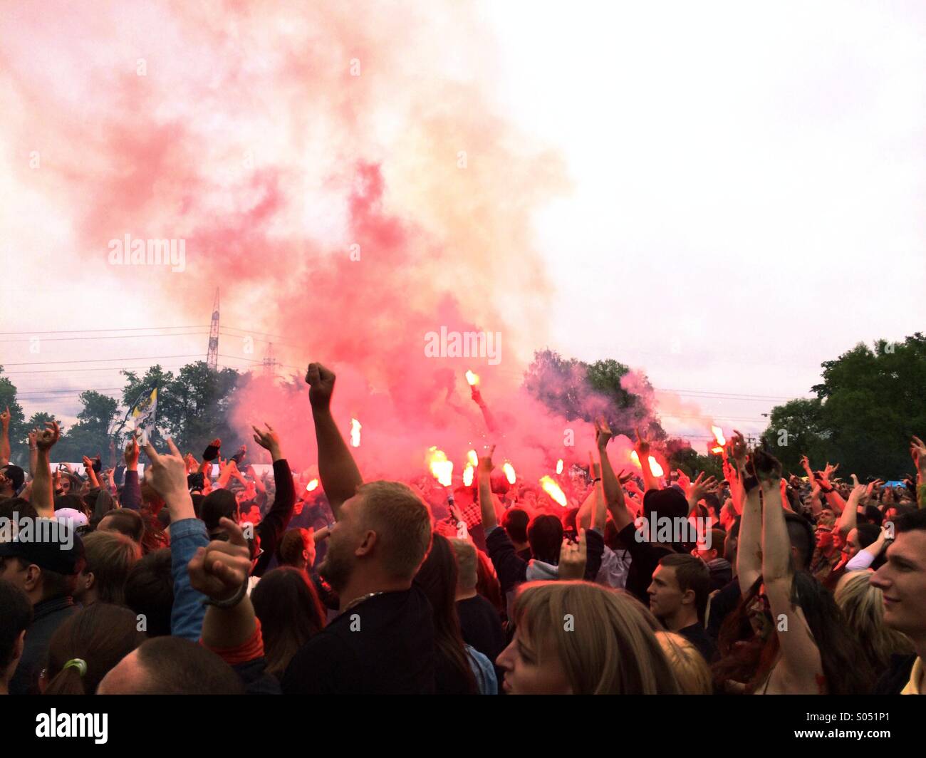 Fire flares in the crowd at rock music concert Stock Photo - Alamy