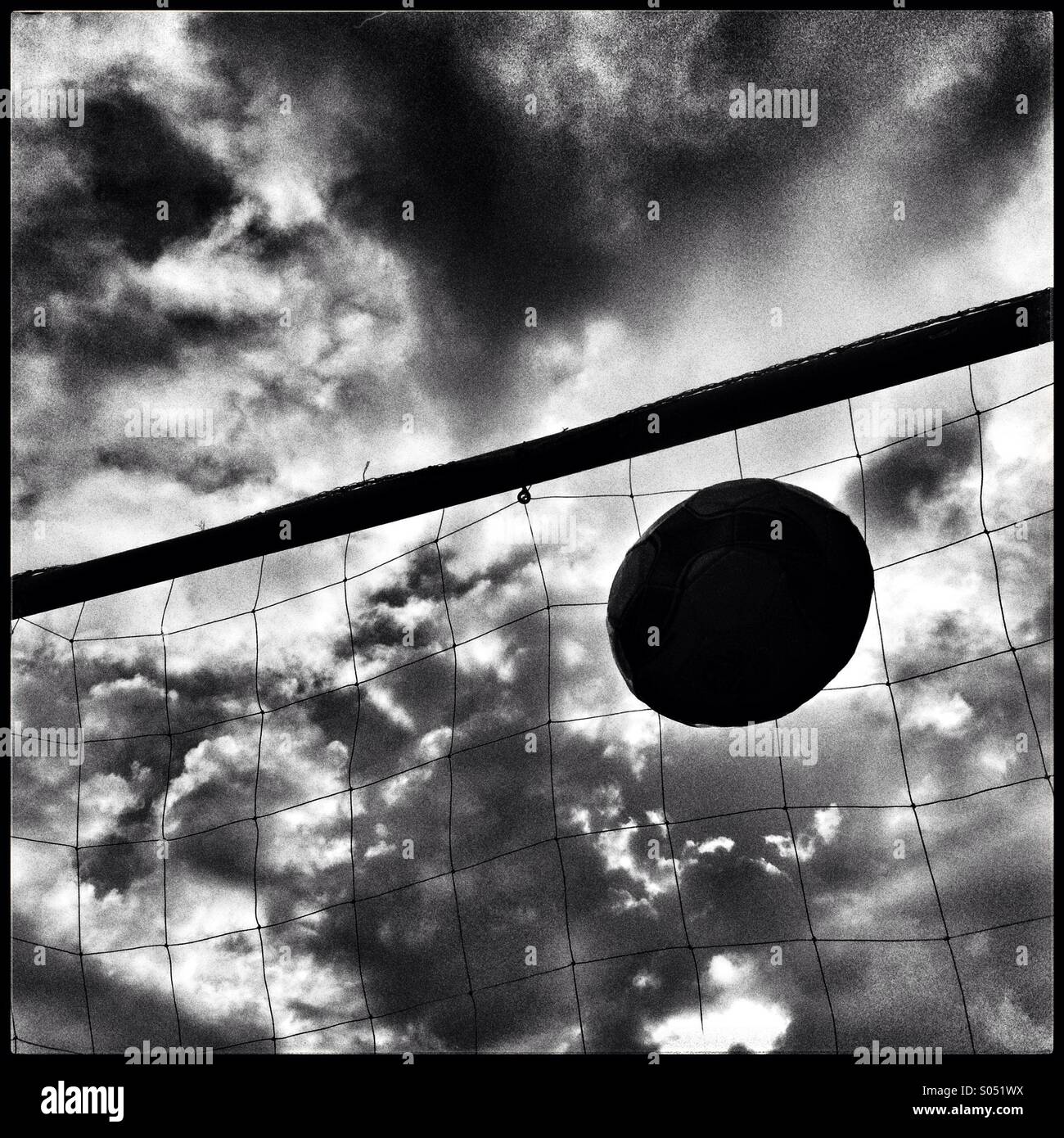 Football flying into net against dramatic sky Stock Photo - Alamy