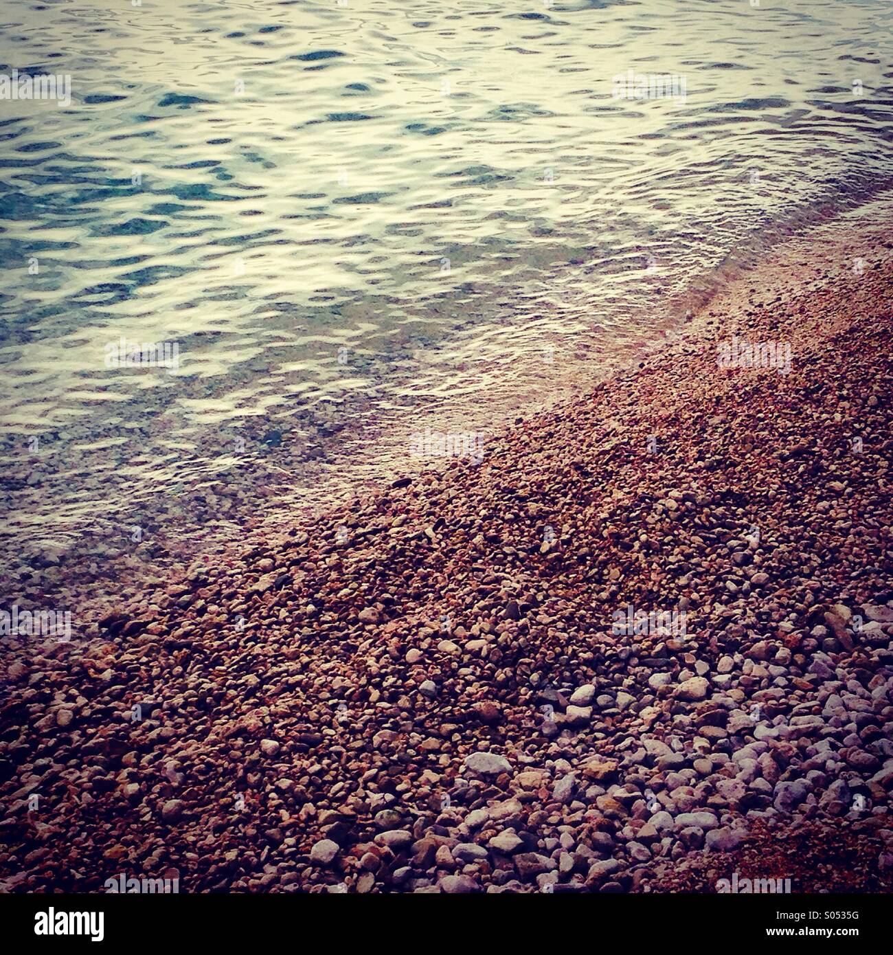 Pebble beach background Stock Photo - Alamy