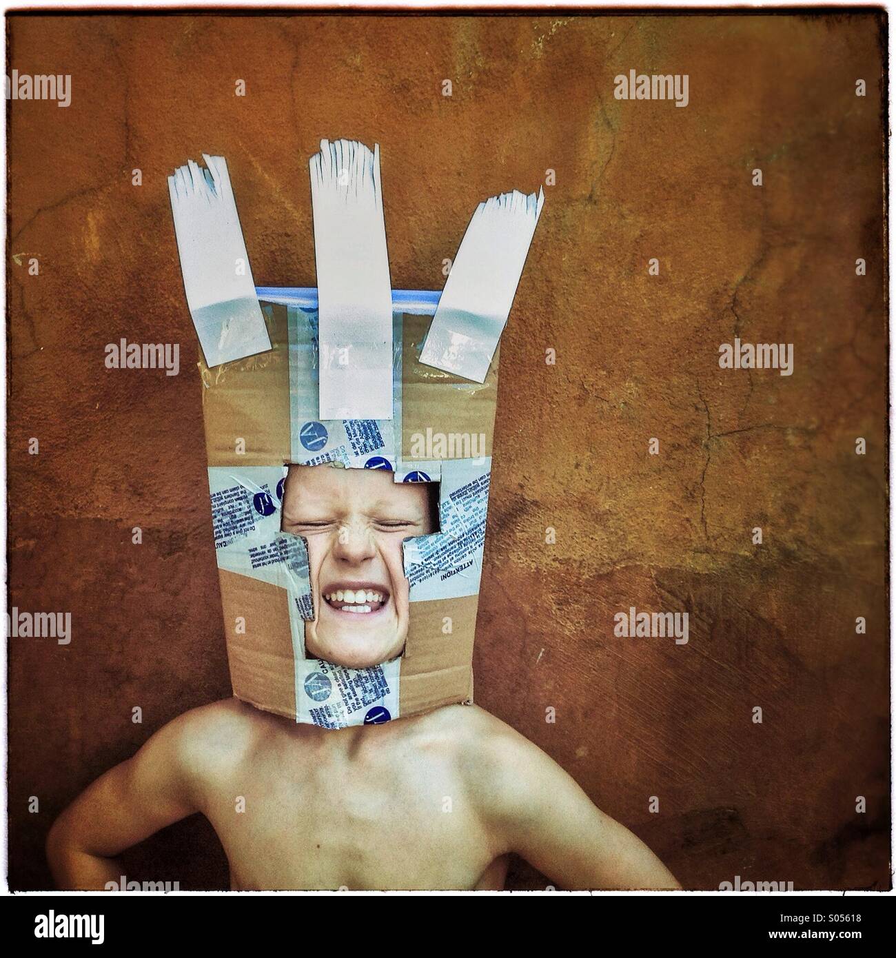 Boy playing with a home made carton mask box Stock Photo - Alamy