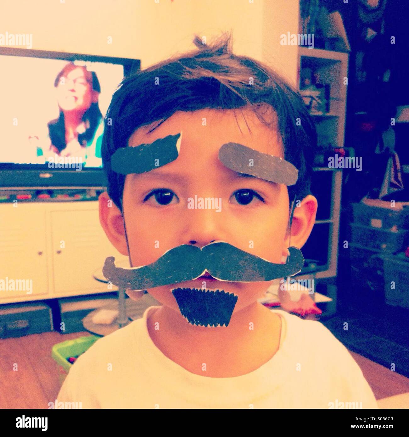 It's a photo of a young child who pretends to be an adult by wearing a ...