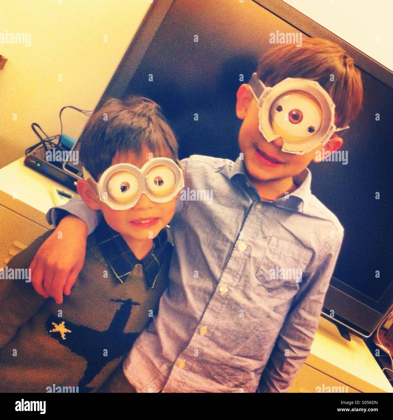 It's a photo of two brothers together playing and pretending they are ...