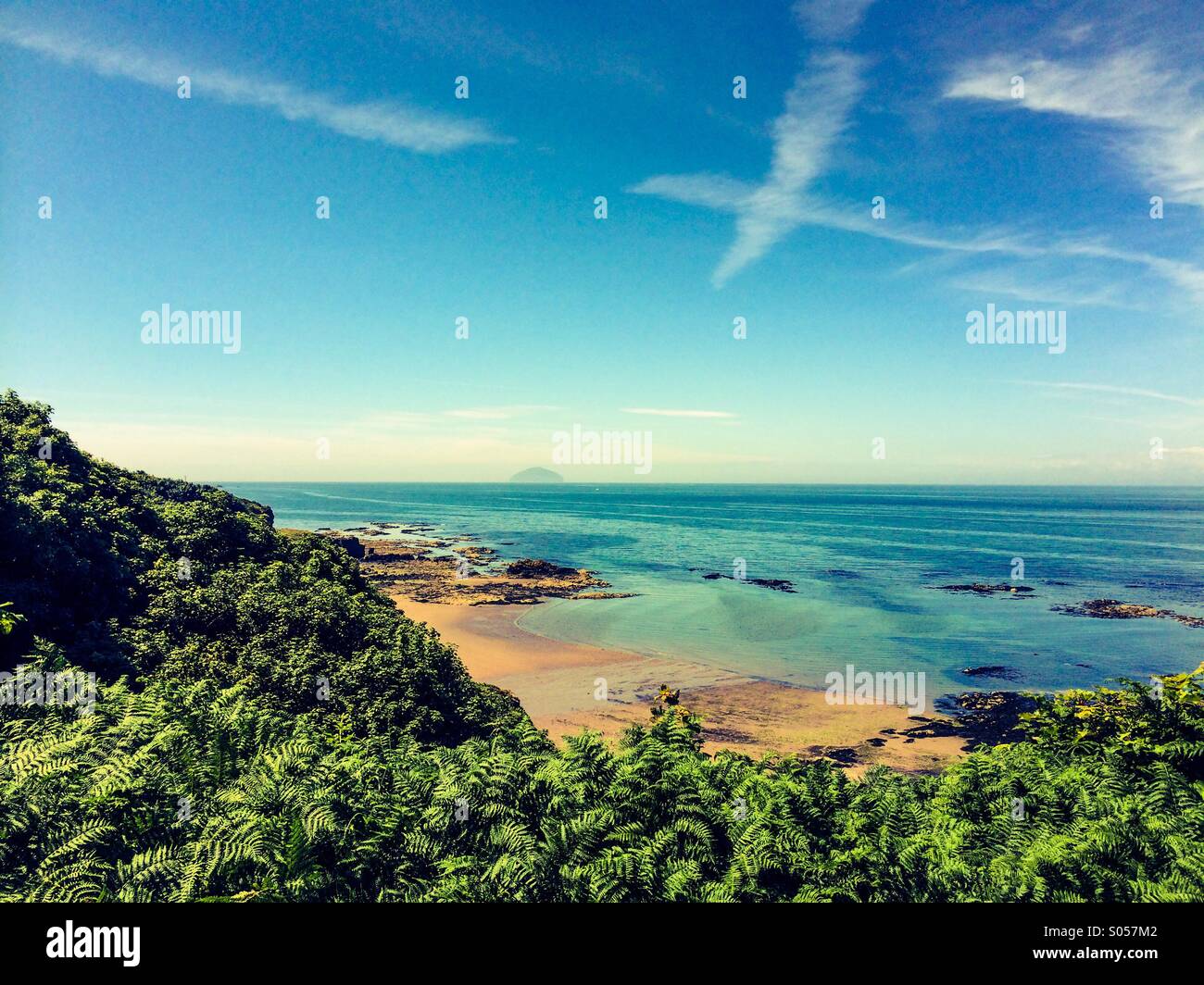 Distant island through the haze Stock Photo - Alamy