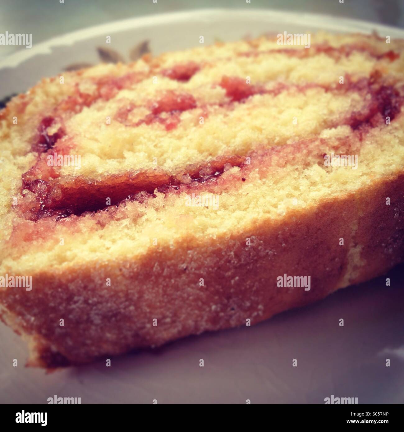 Slice of Jam swiss roll cake Stock Photo - Alamy
