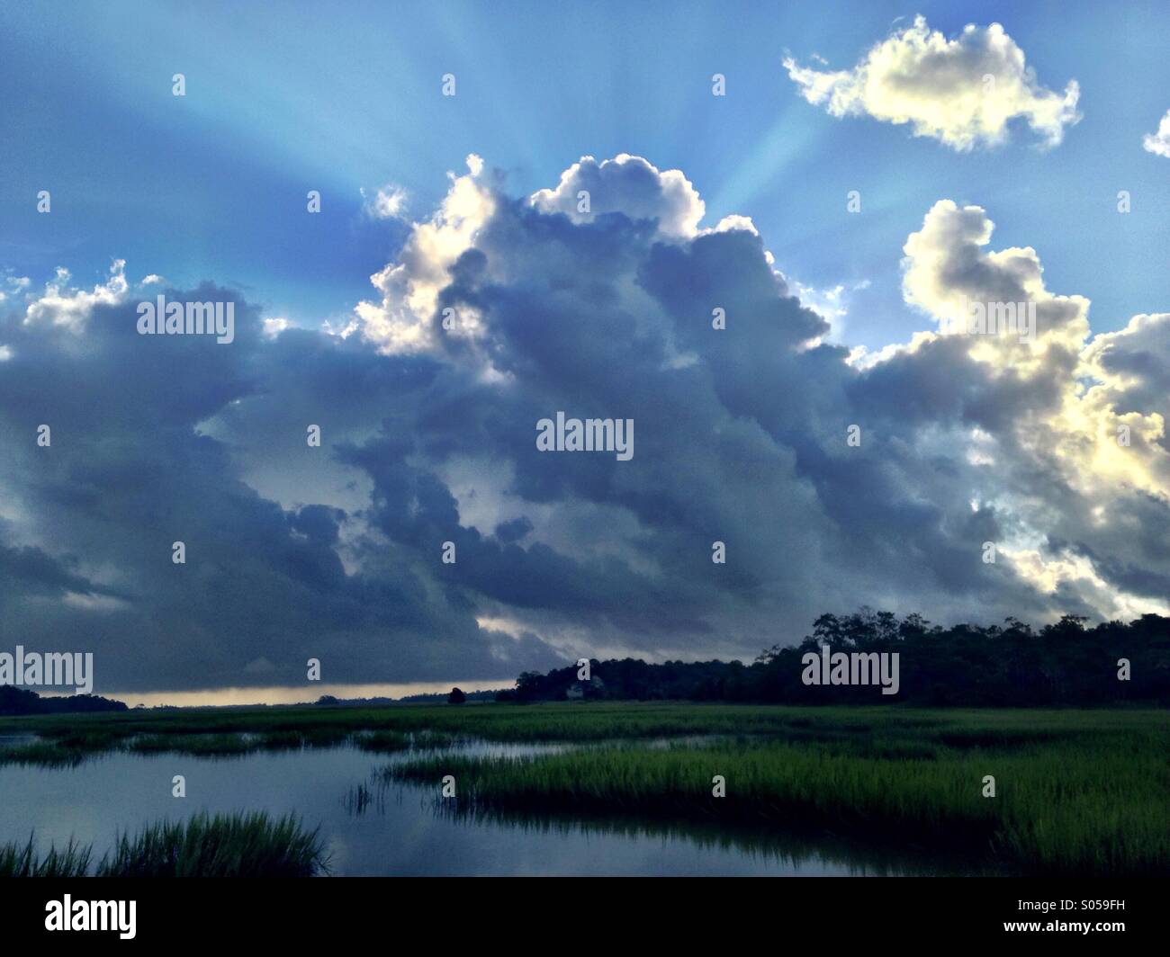 Storm Clouds and Sunbeams Over a Southern Marsh in South Carolina Stock ...