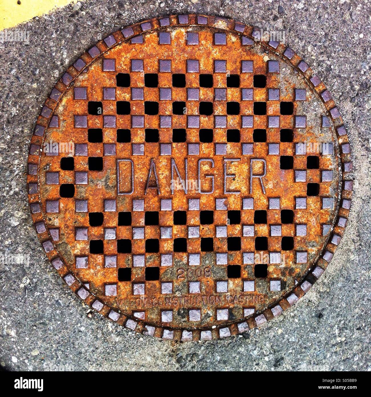 Word DANGER on the top of the rusty manhole cover, 2014 Stock Photo - Alamy