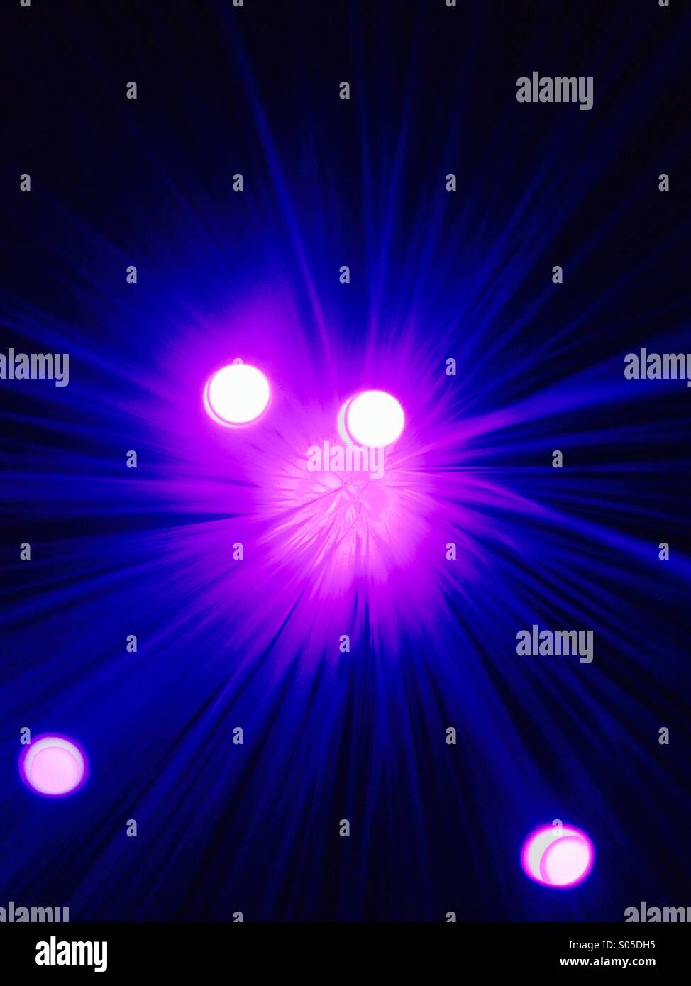 Fibre optic strands emitting blue light Stock Photo - Alamy