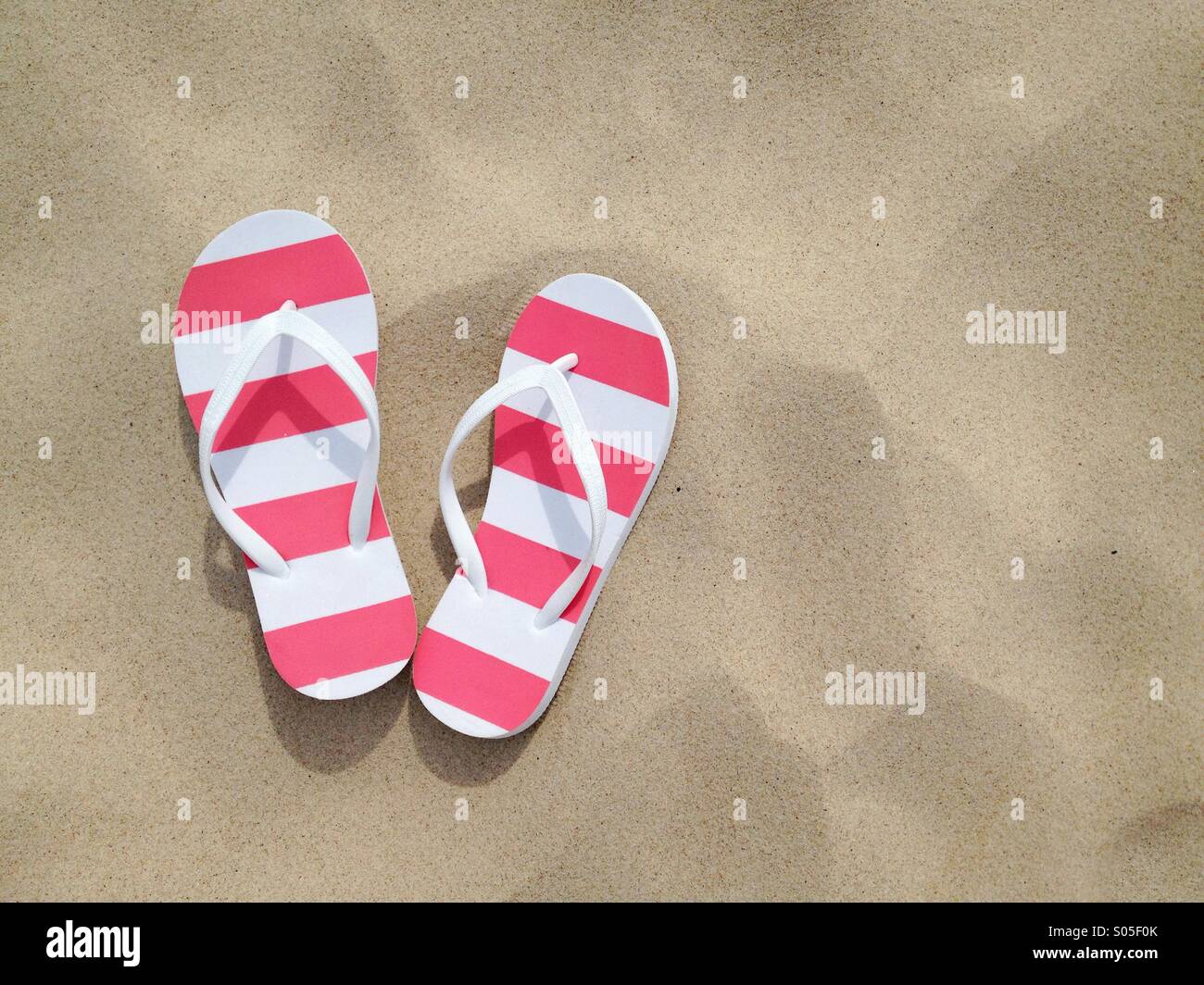 Flip flops on the beach Stock Photo - Alamy