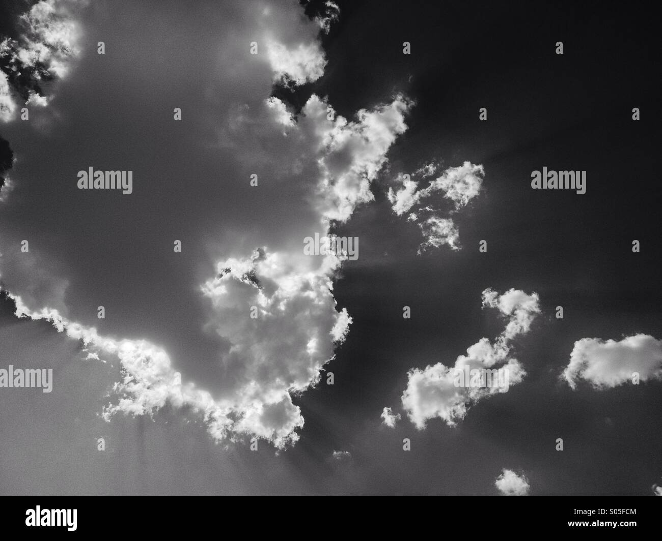 Back lighted clouds in a blue sky Stock Photo - Alamy