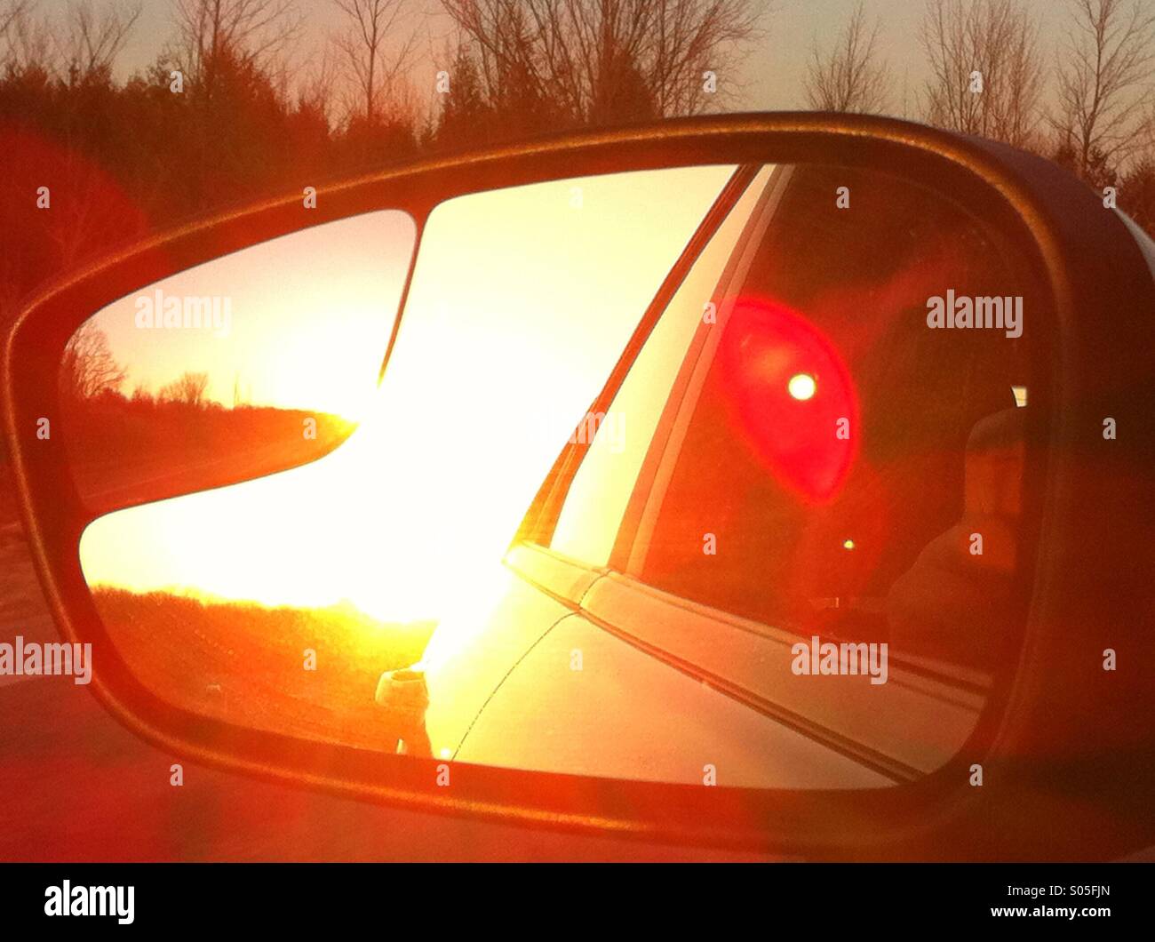 Sunset through side view mirror Stock Photo - Alamy