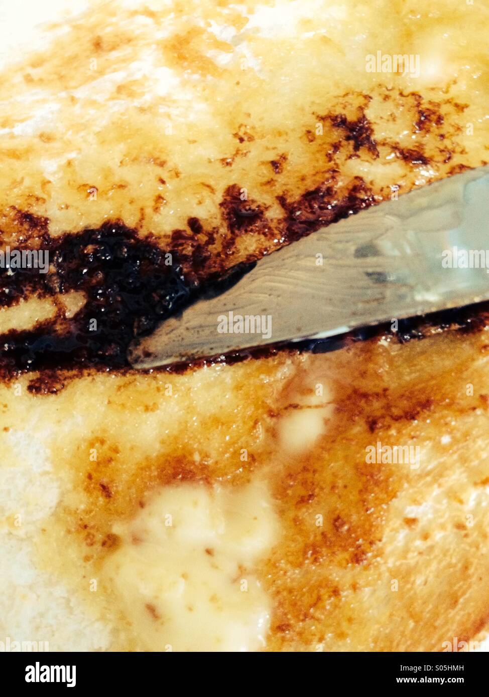 Spreading bovril on toast Stock Photo - Alamy