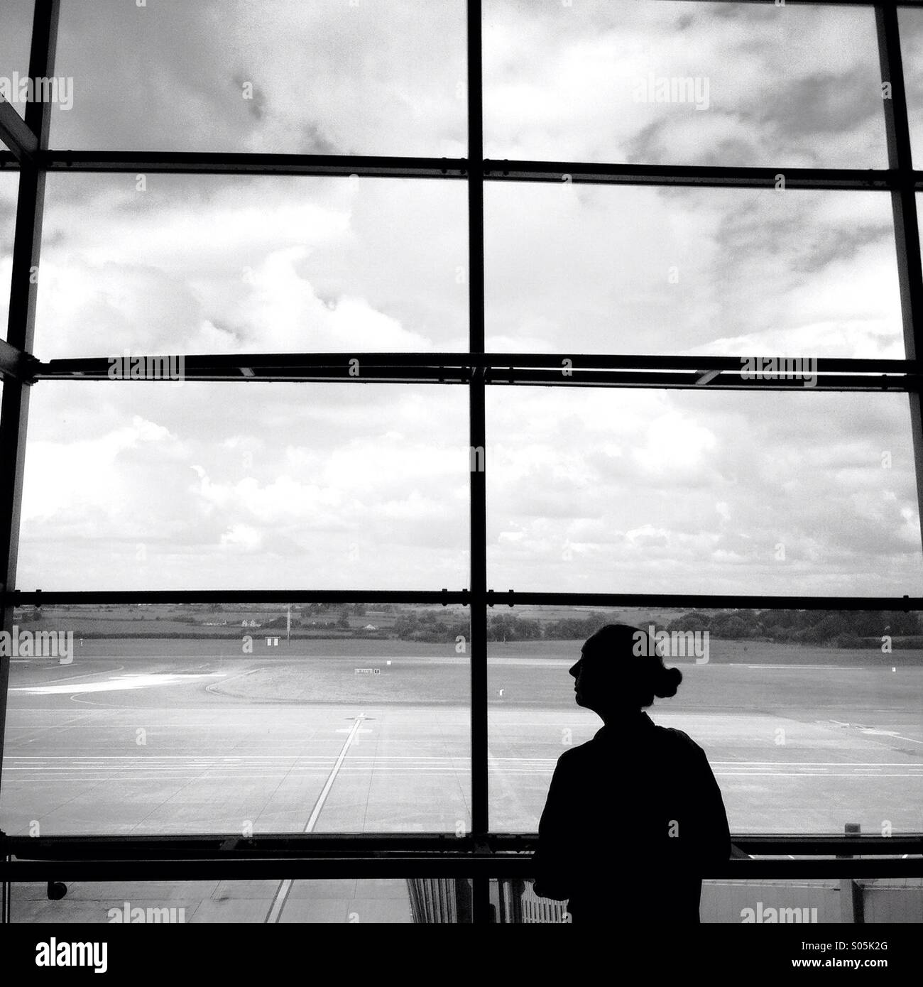 A woman looks out the windows at the Cork international airport. Cork ...