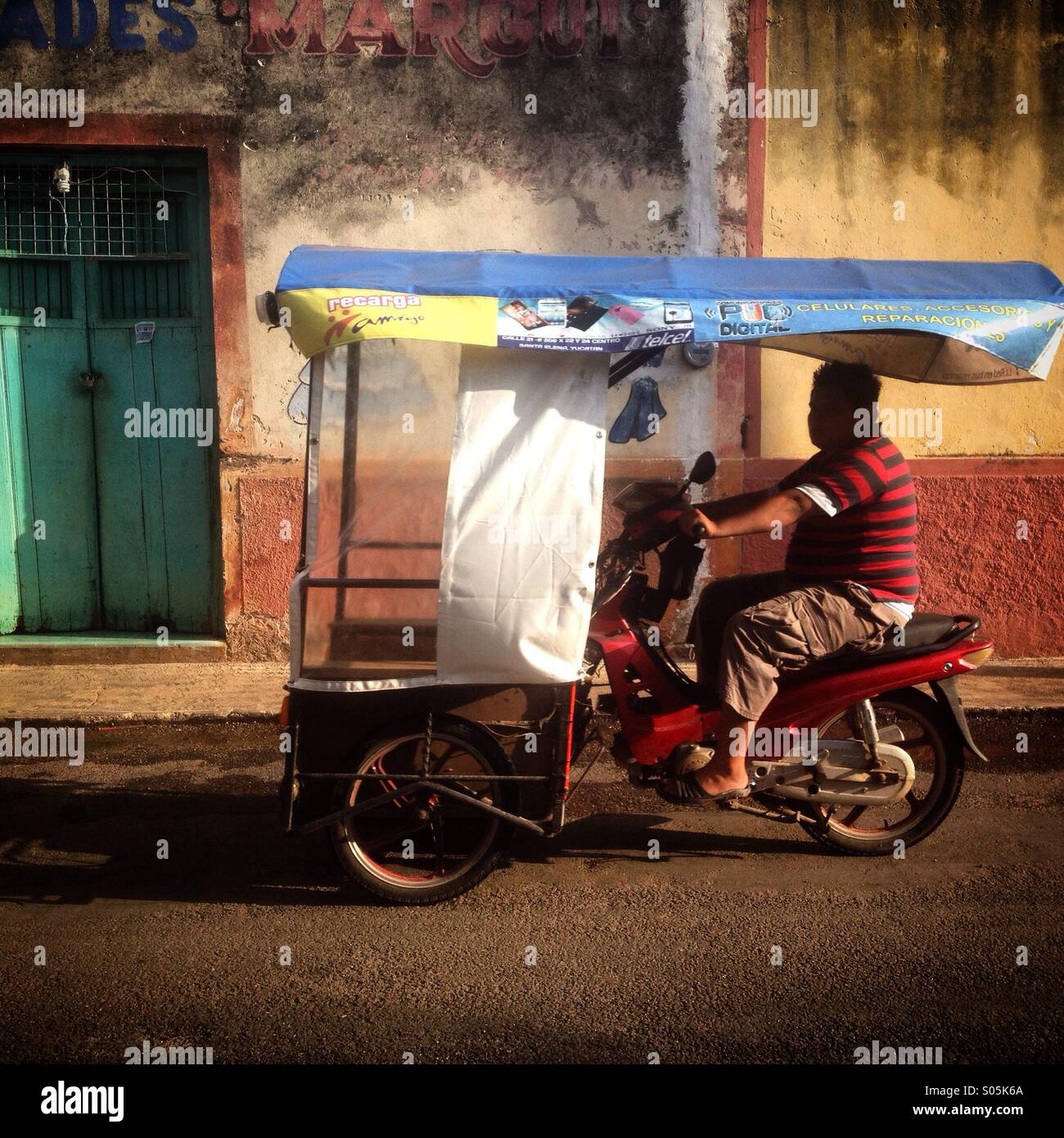 A man drives a motorcycle taxi in Santa Elena, Yucatan, Mexico Stock ...