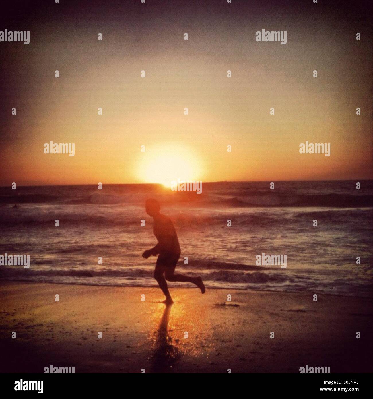 Man running along the beach hi-res stock photography and images - Alamy