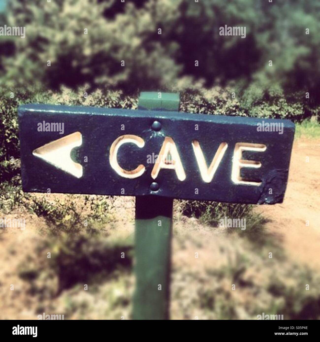 Sign saying cave with an arrow Stock Photo - Alamy
