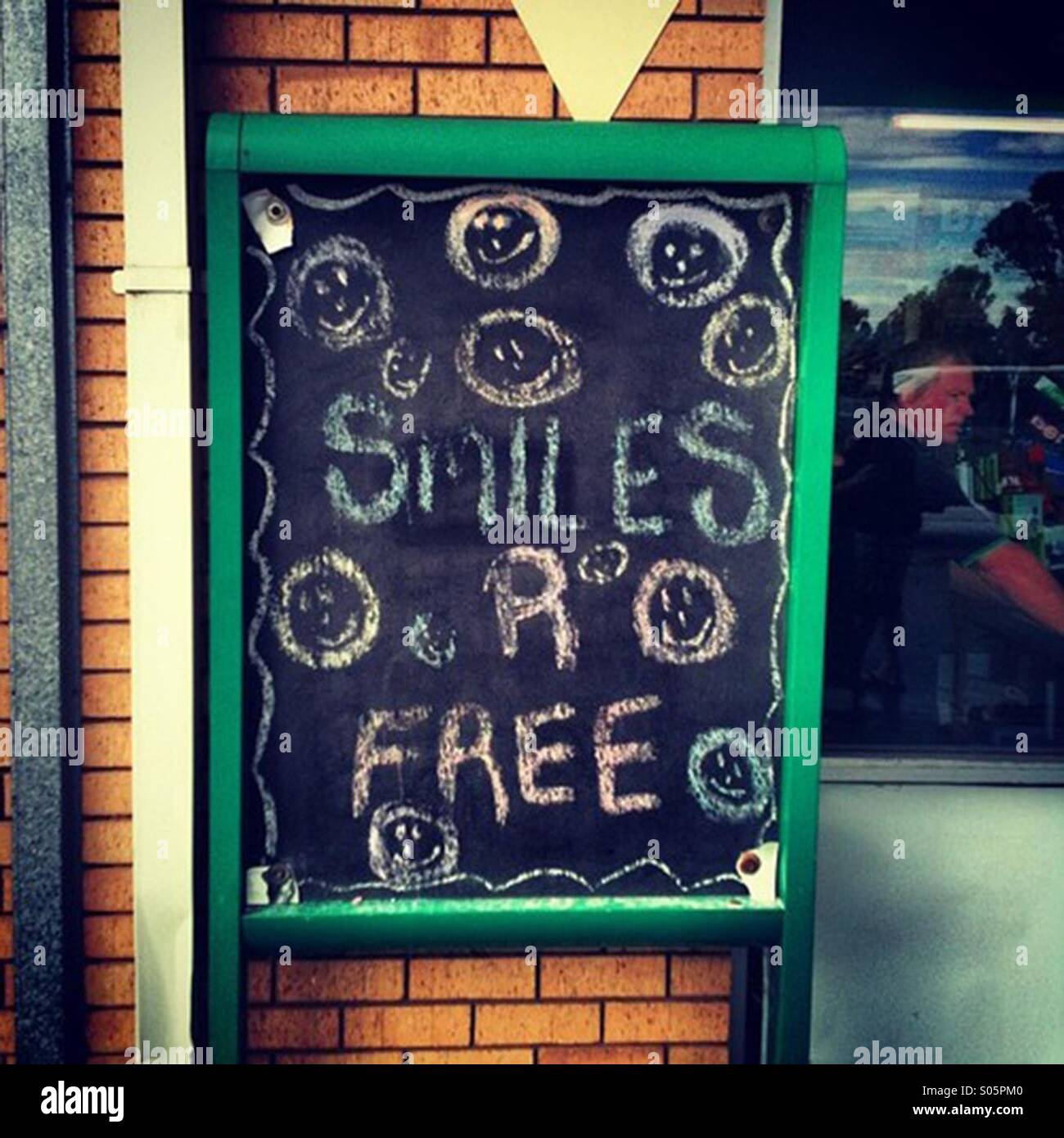 Smiles are free chalkboard sign in Australia Stock Photo - Alamy