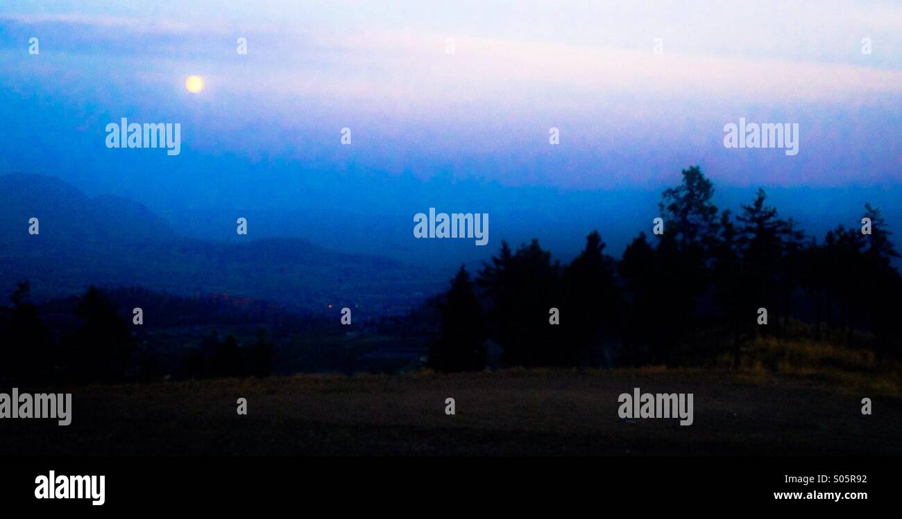 Full moon over the valley on a summer evening Stock Photo - Alamy