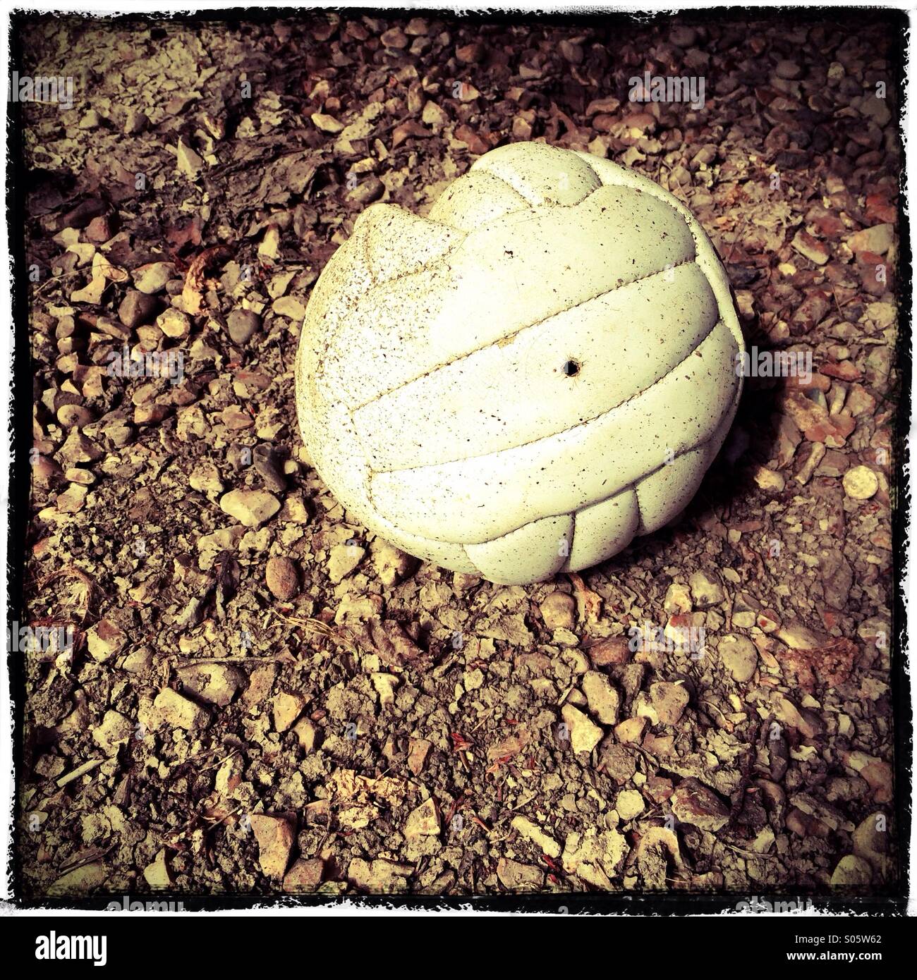 Burst old football Stock Photo - Alamy