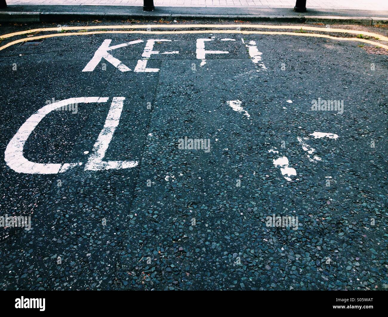 Keep clear, faded urban street sign Stock Photo - Alamy