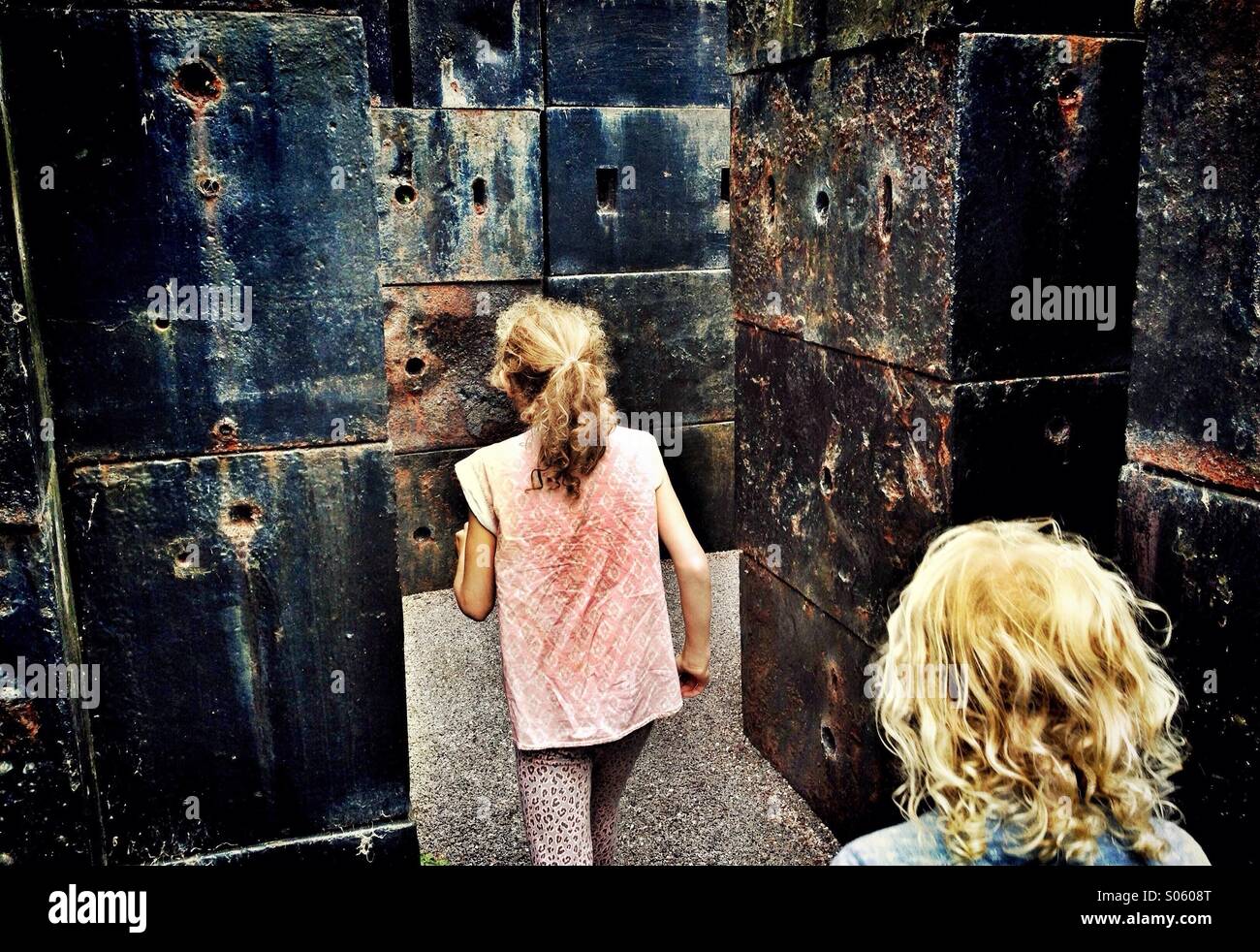 Two girls running through maze Stock Photo - Alamy