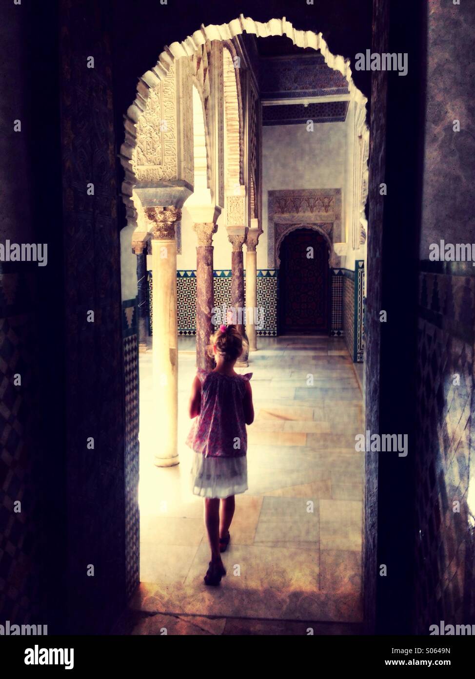 Girl through arch Stock Photo - Alamy