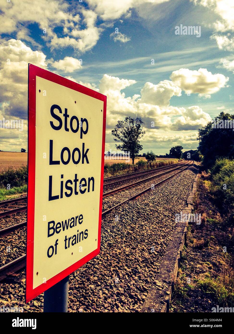 Warning sign at rail crossing, England, UK Stock Photo - Alamy