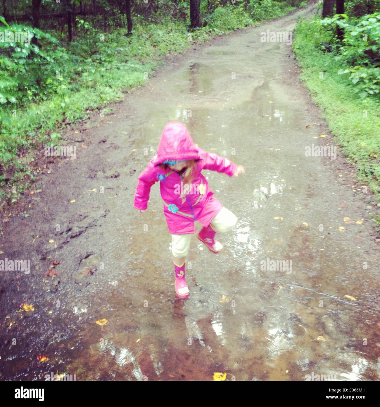 Child splashing puddles hi-res stock photography and images - Alamy