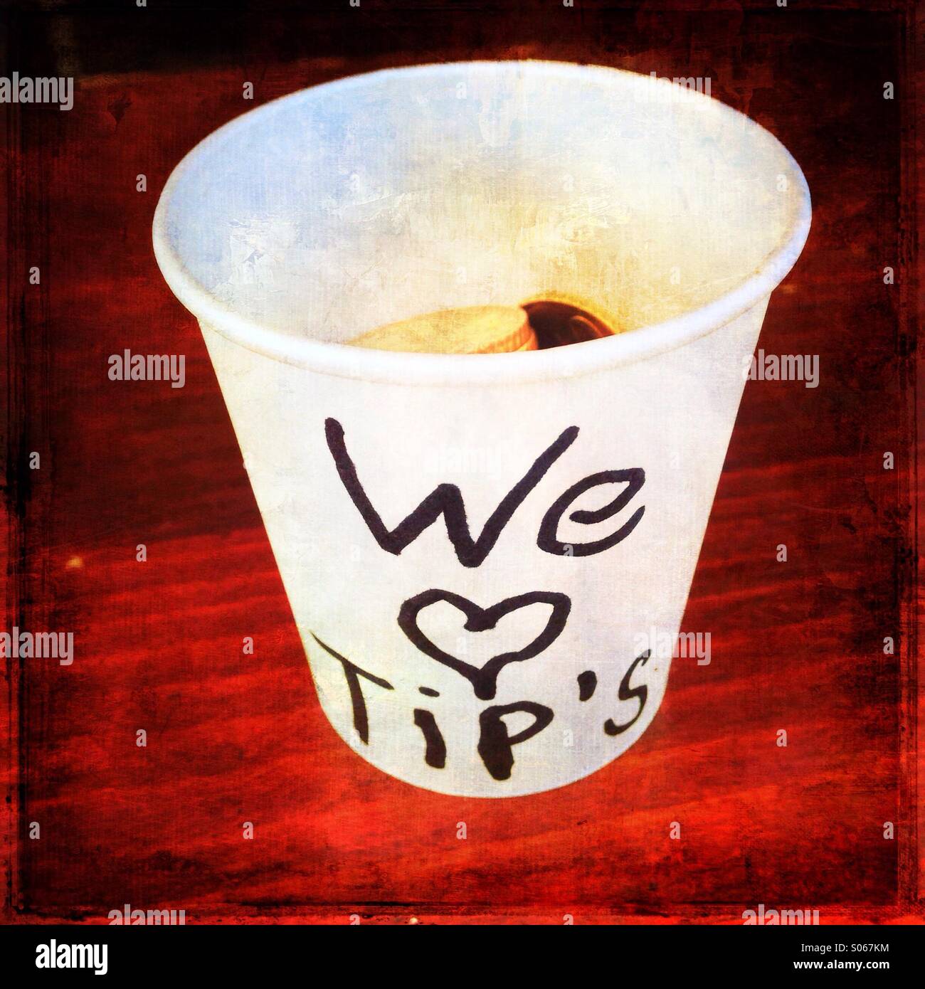 Tips cup on counter in Berlin cafe Stock Photo - Alamy