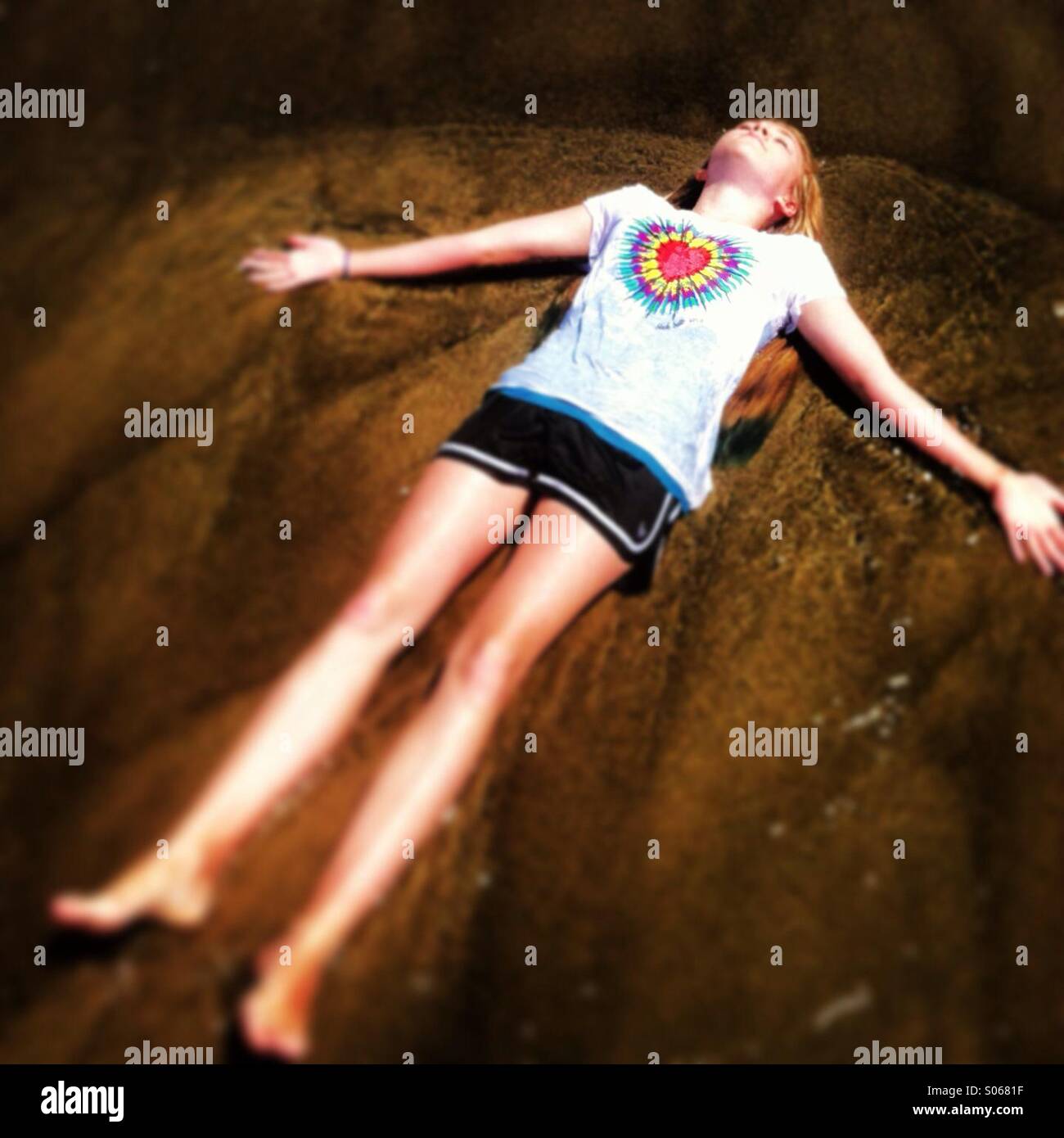 Girl laying in Ocean Stock Photo - Alamy