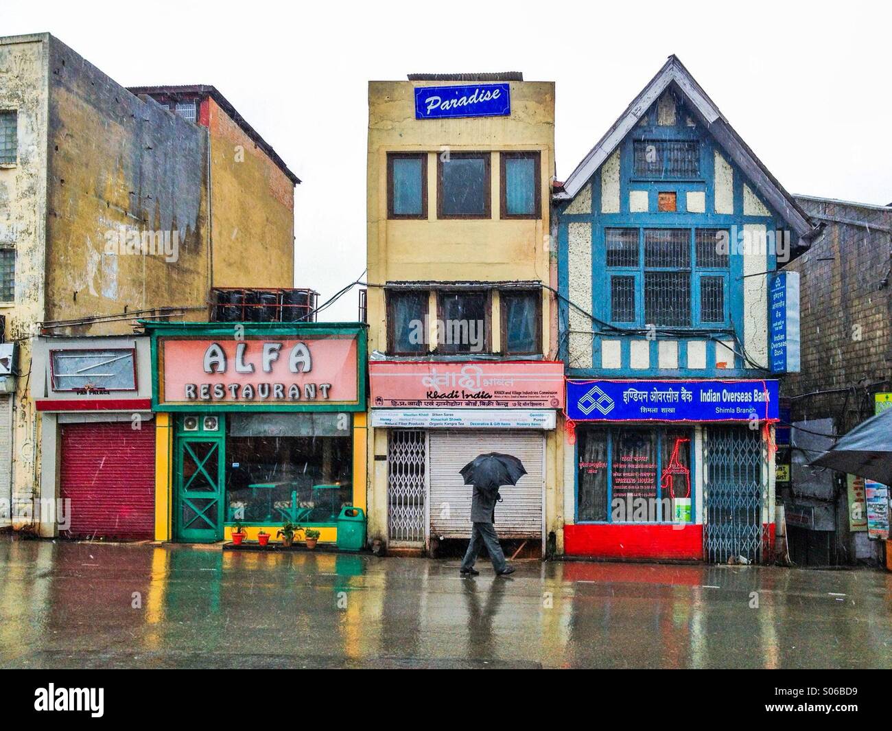 A man walks as the snow starts to fall at the scandal point of Shimla ...