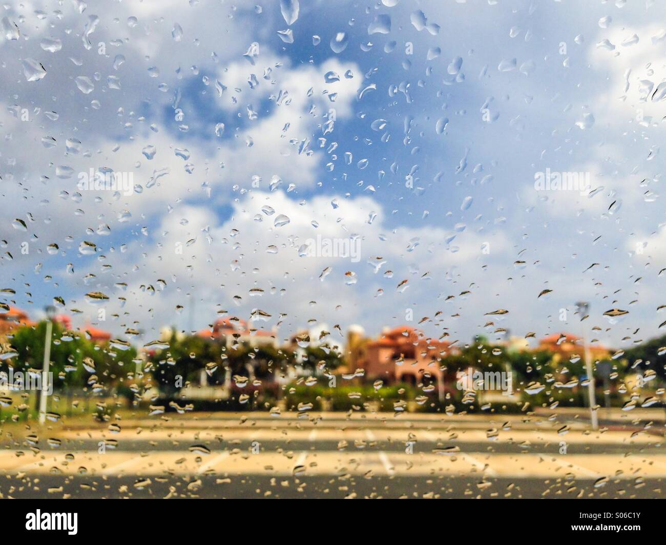 Rain drops on a windscreen in front of pretty residential houses Stock ...