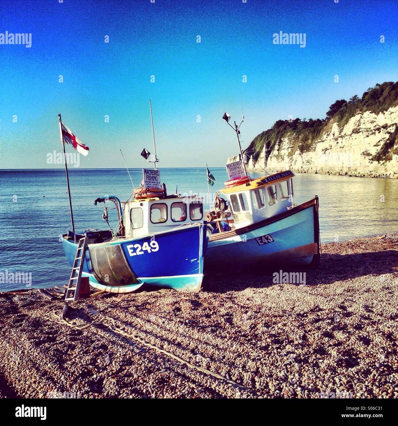 Two fishing boats on a beach waiting to be launched Stock Photo - Alamy