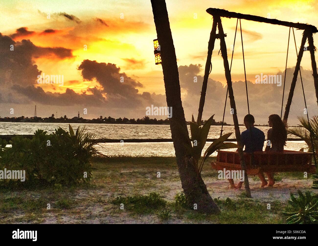 Young couple in paradise sunset Stock Photo - Alamy