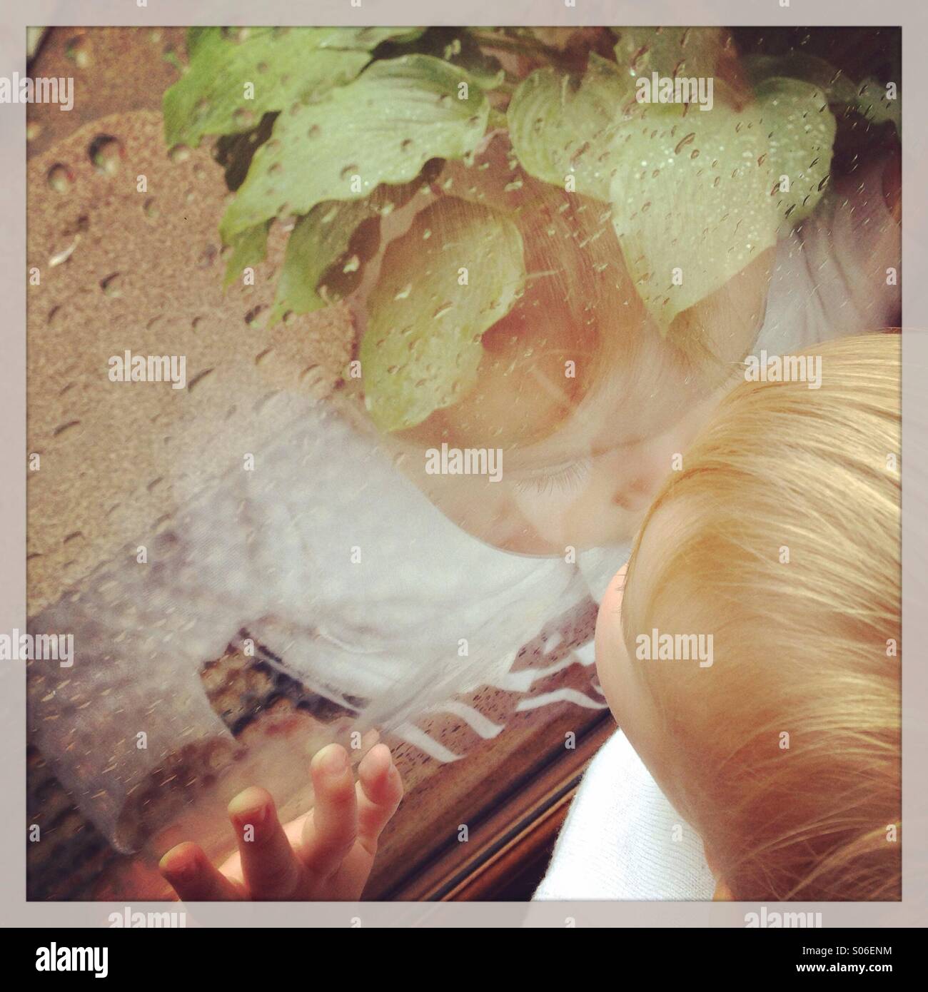 Child looking out of window on a rainy day Stock Photo - Alamy