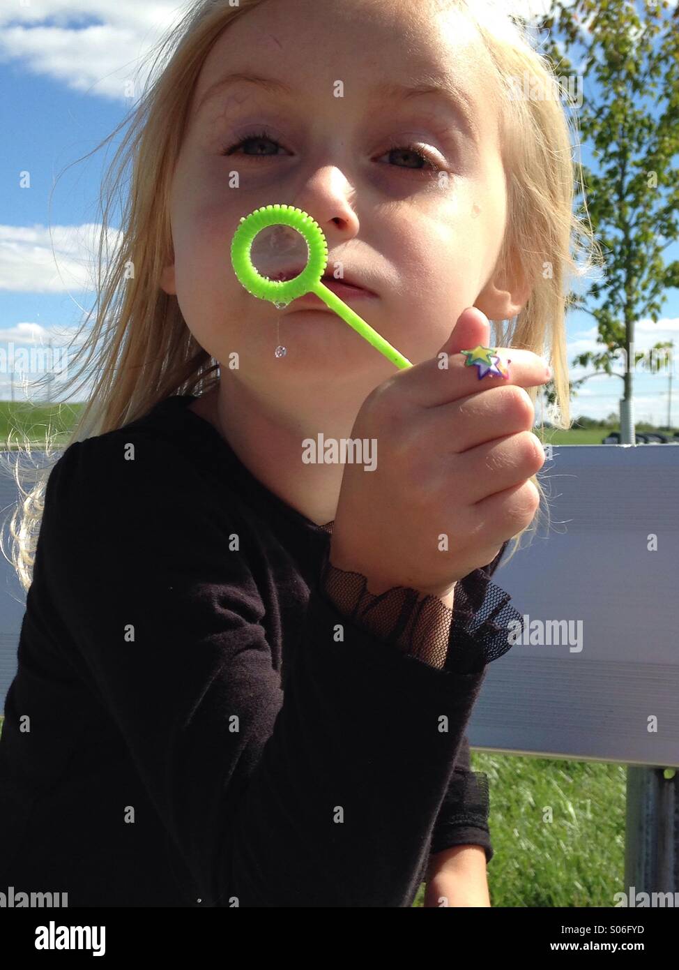 A sleepy girl blowing bubbles Stock Photo - Alamy