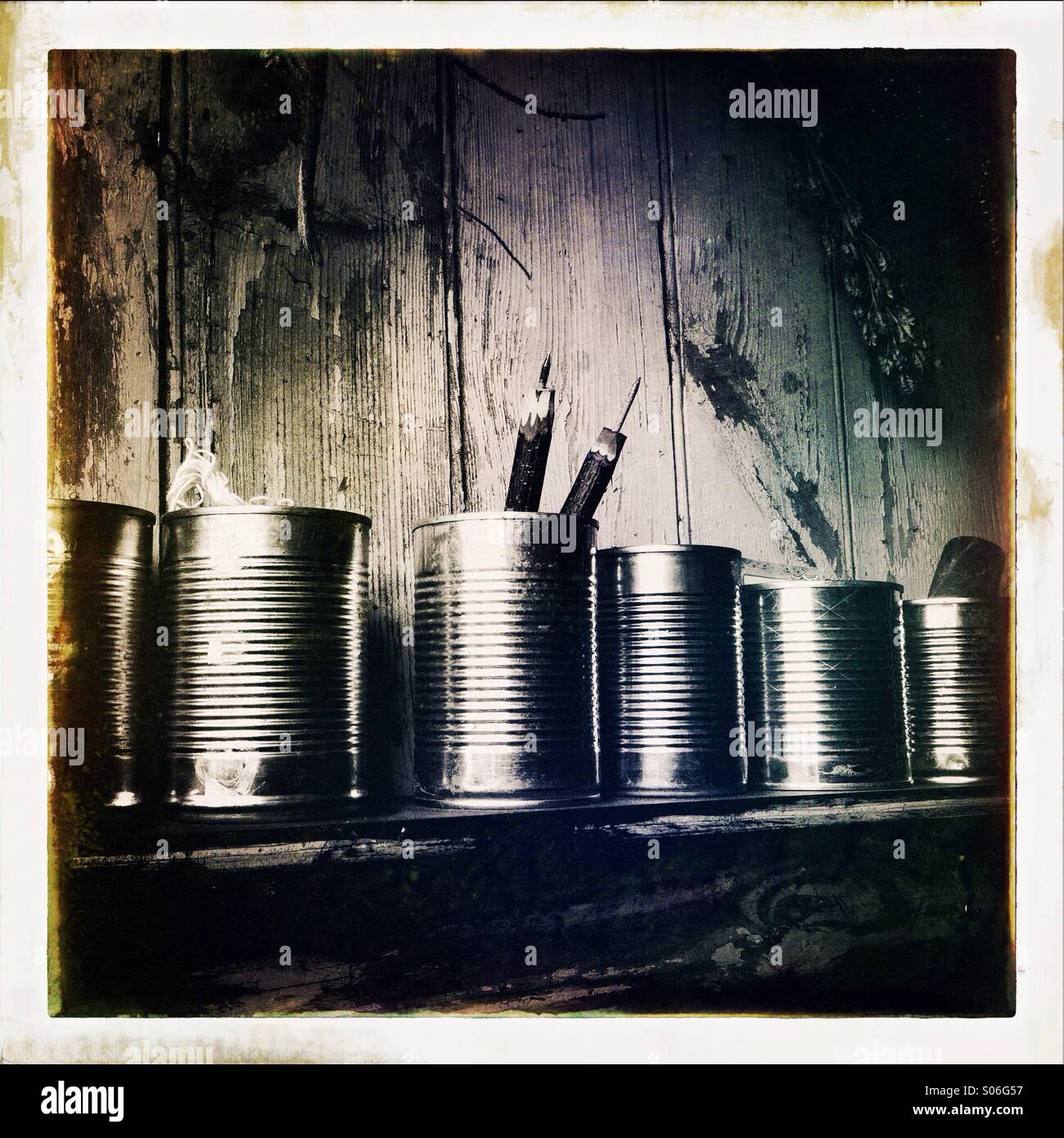 Shiny tins, recycled to become simple crafted pen pots in a shepherd's ...