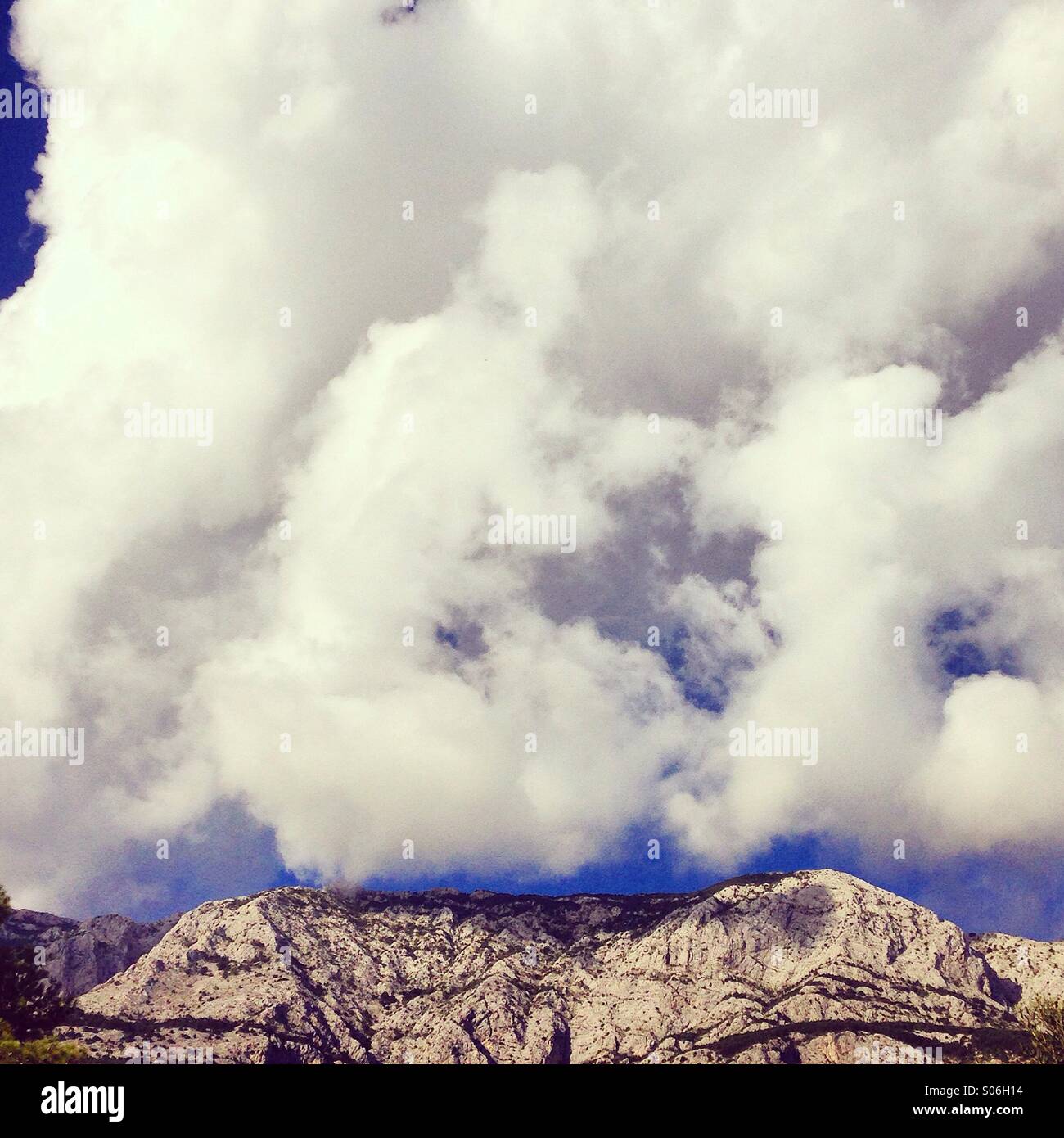 Clouds over mountain background Stock Photo - Alamy