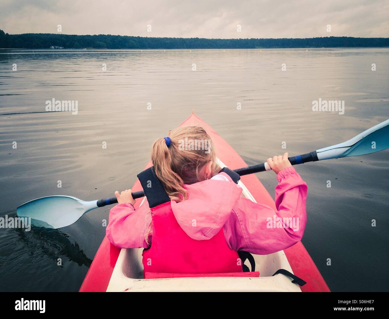 Little girl in kayak on a lake Stock Photo - Alamy