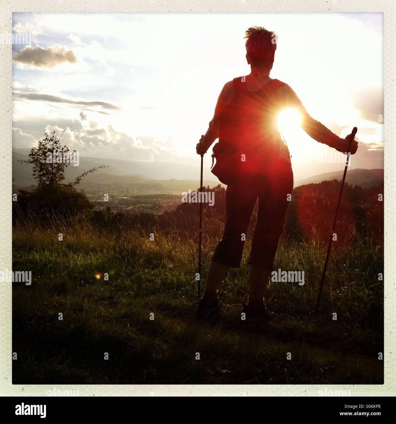 Female hiker in sunset, shot from back Stock Photo - Alamy