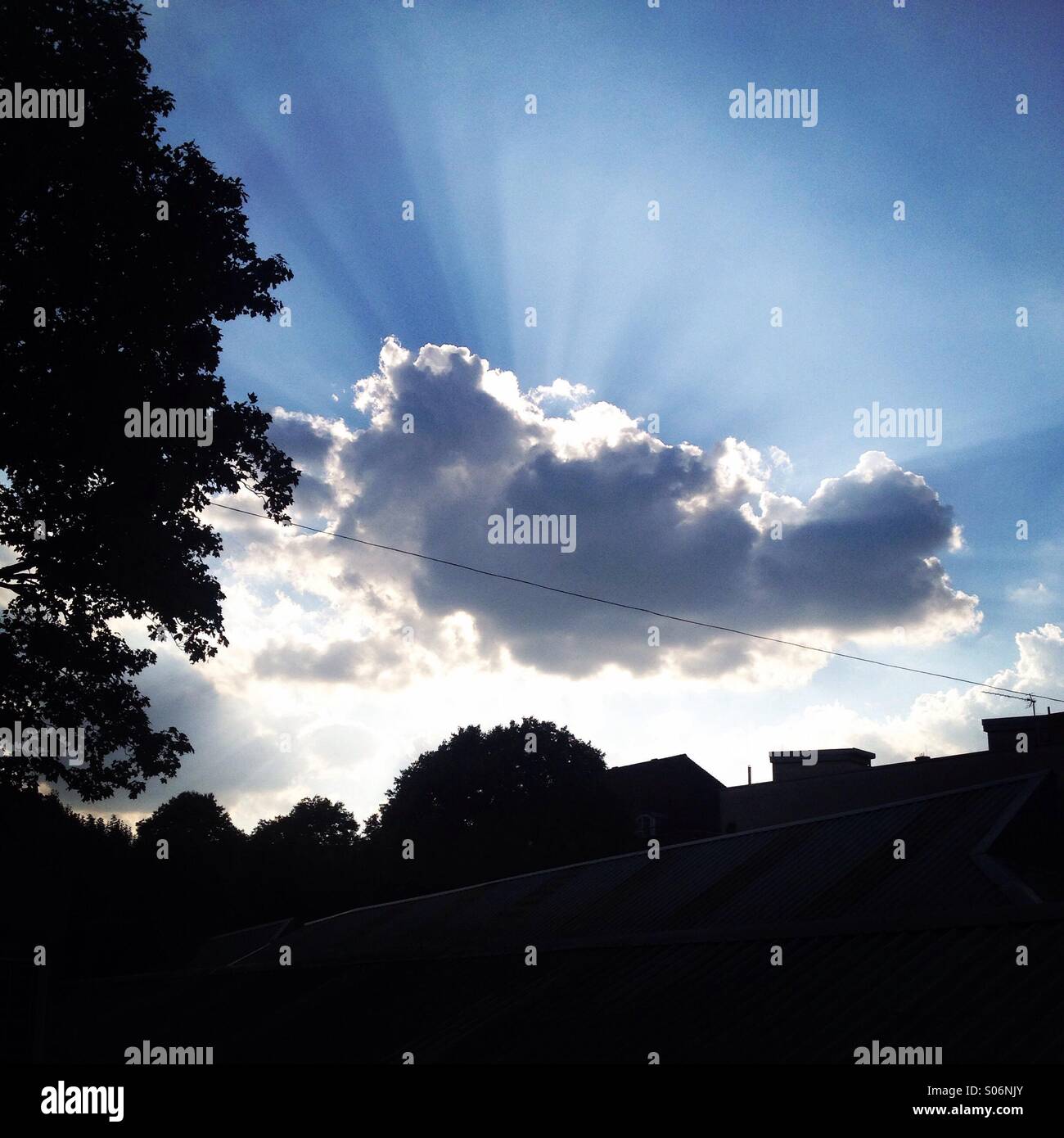 Cloud and sun beams above London rooftop Stock Photo - Alamy