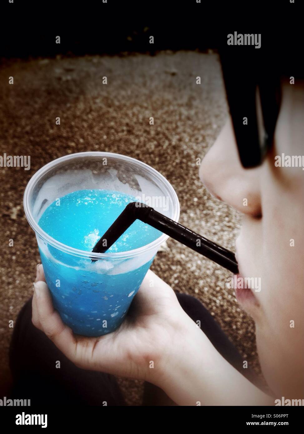Girl drinking blue slush drink Stock Photo - Alamy