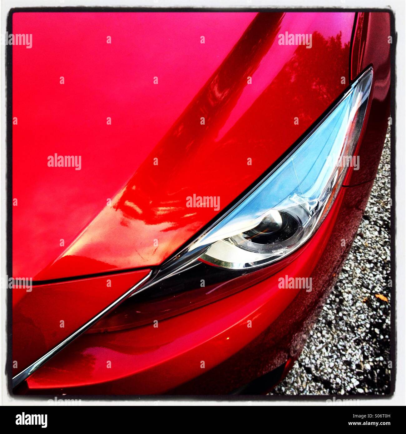 High gloss red car fender and headlight detail on asphalt background ...