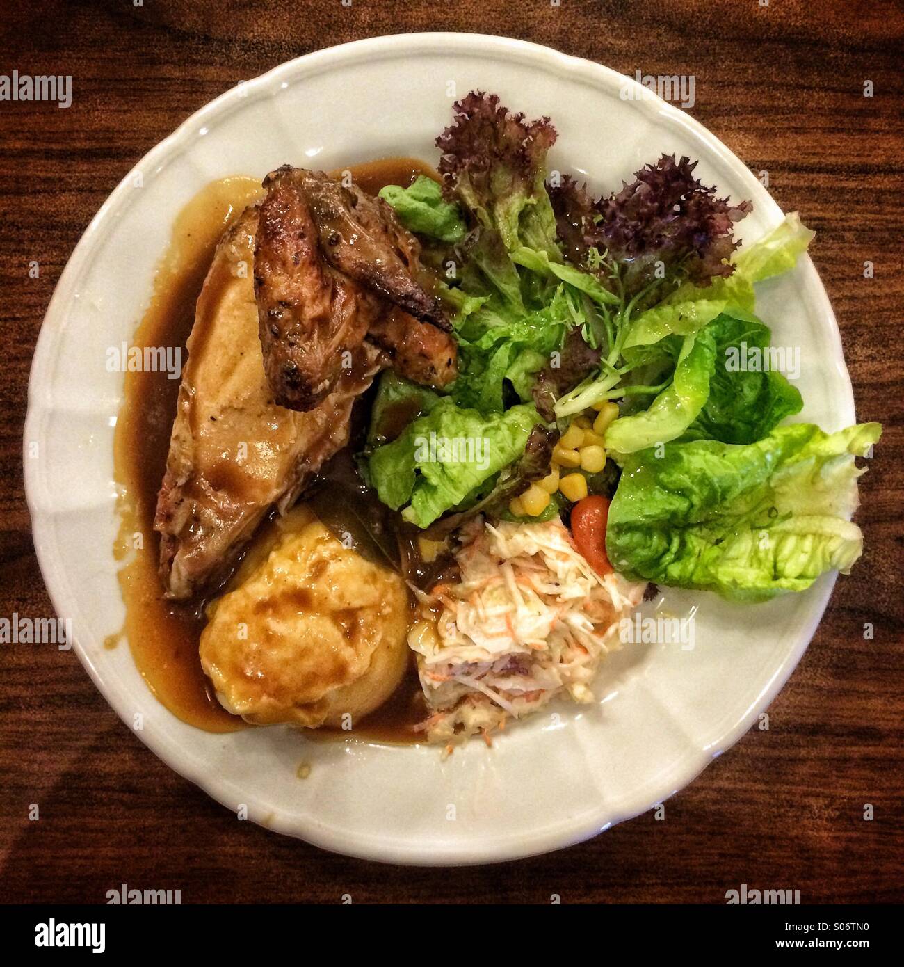 Plate of quarter roast chicken with mashed potato and salad Stock Photo ...