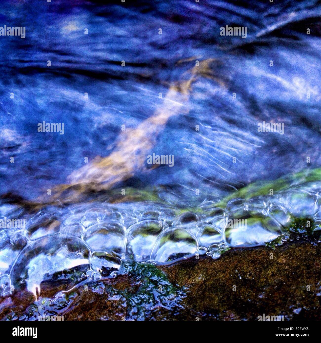 Fast flowing stream snd bubbles Stock Photo - Alamy