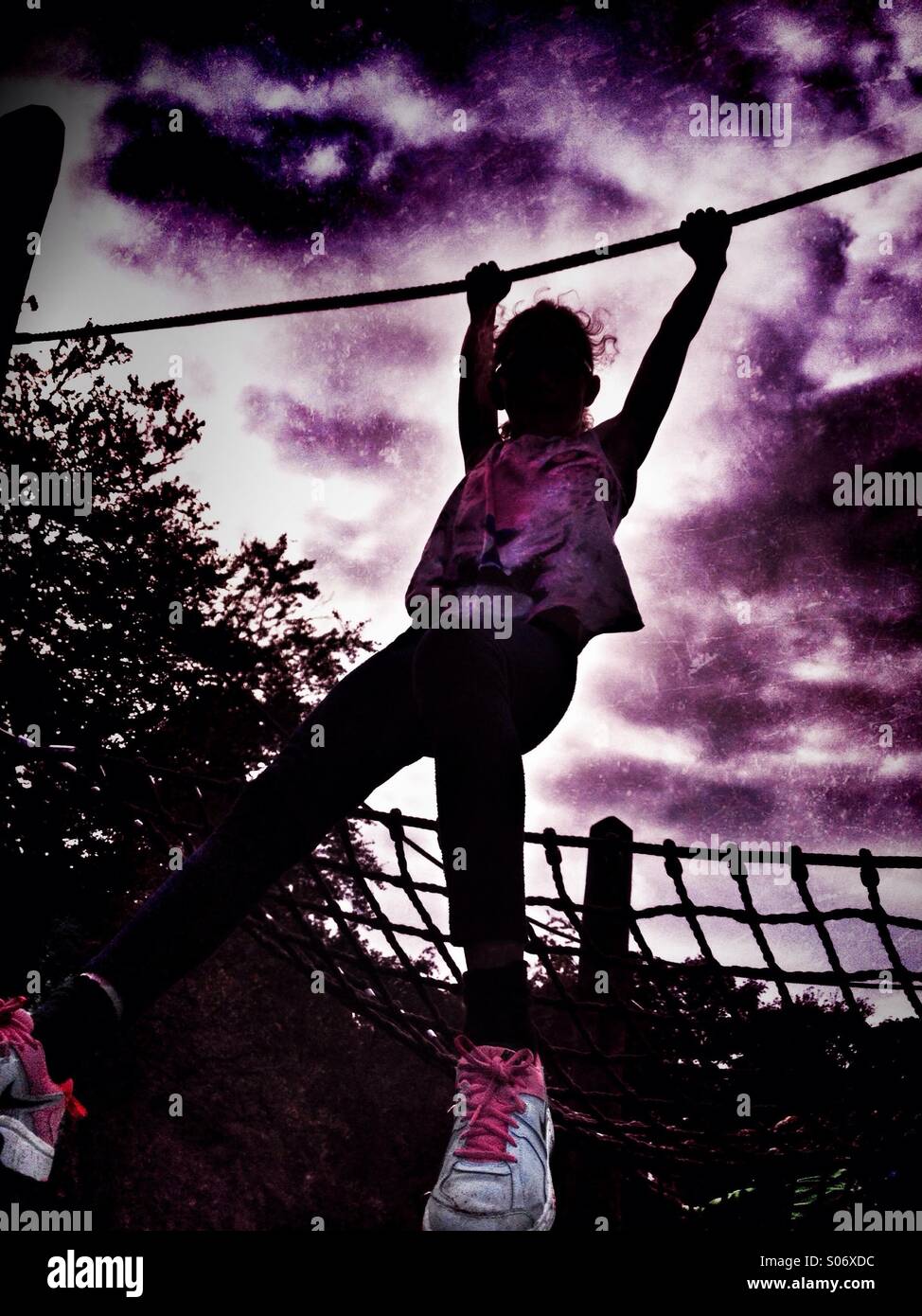 Girl swinging on rope Stock Photo - Alamy