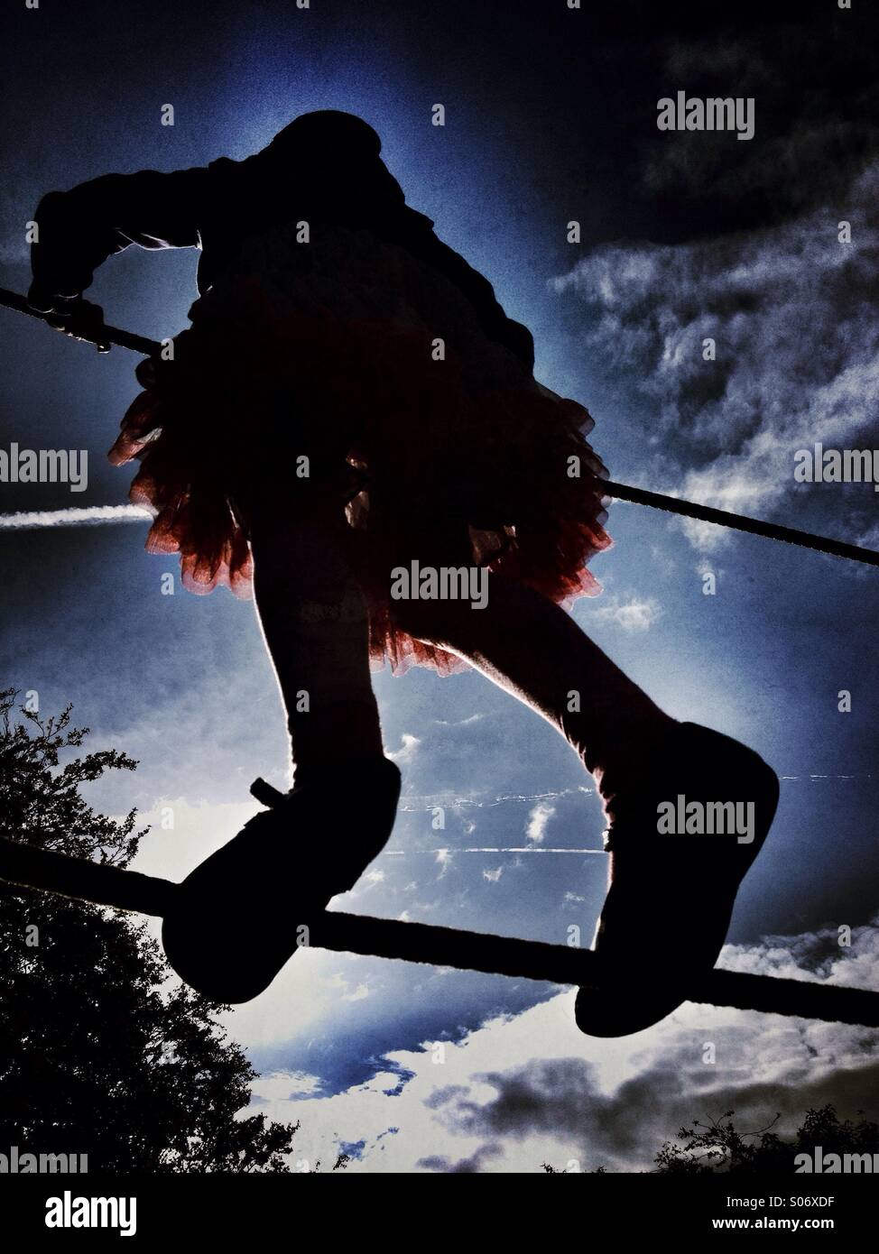 Young girl balancing on rope walk Stock Photo - Alamy