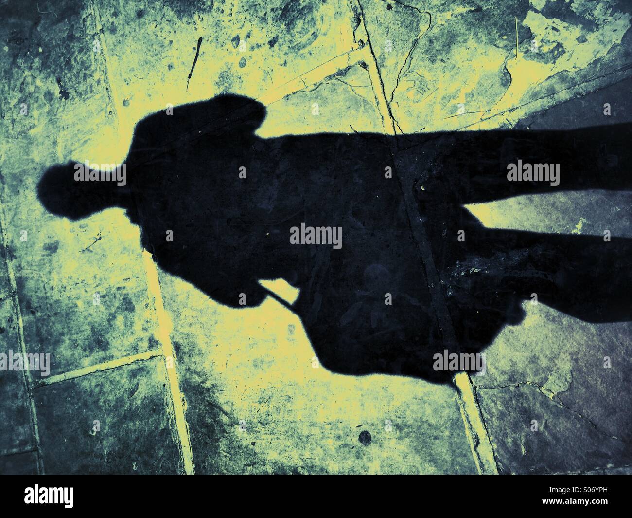 Shadow on the pavement of a man carrying a large bag Stock Photo - Alamy